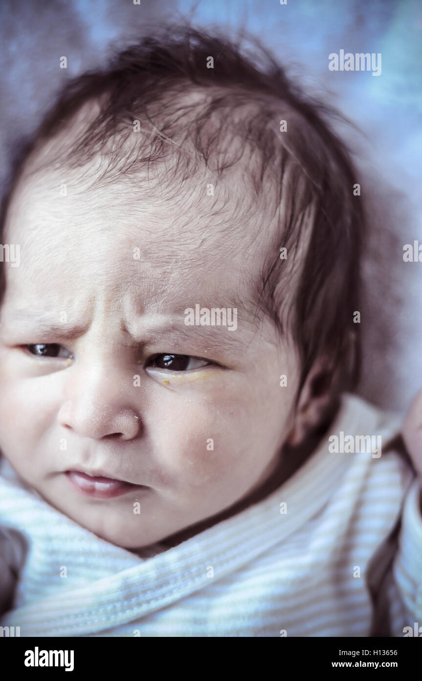 new born baby curled up sleeping on a blanket, multiple expressi Stock ...