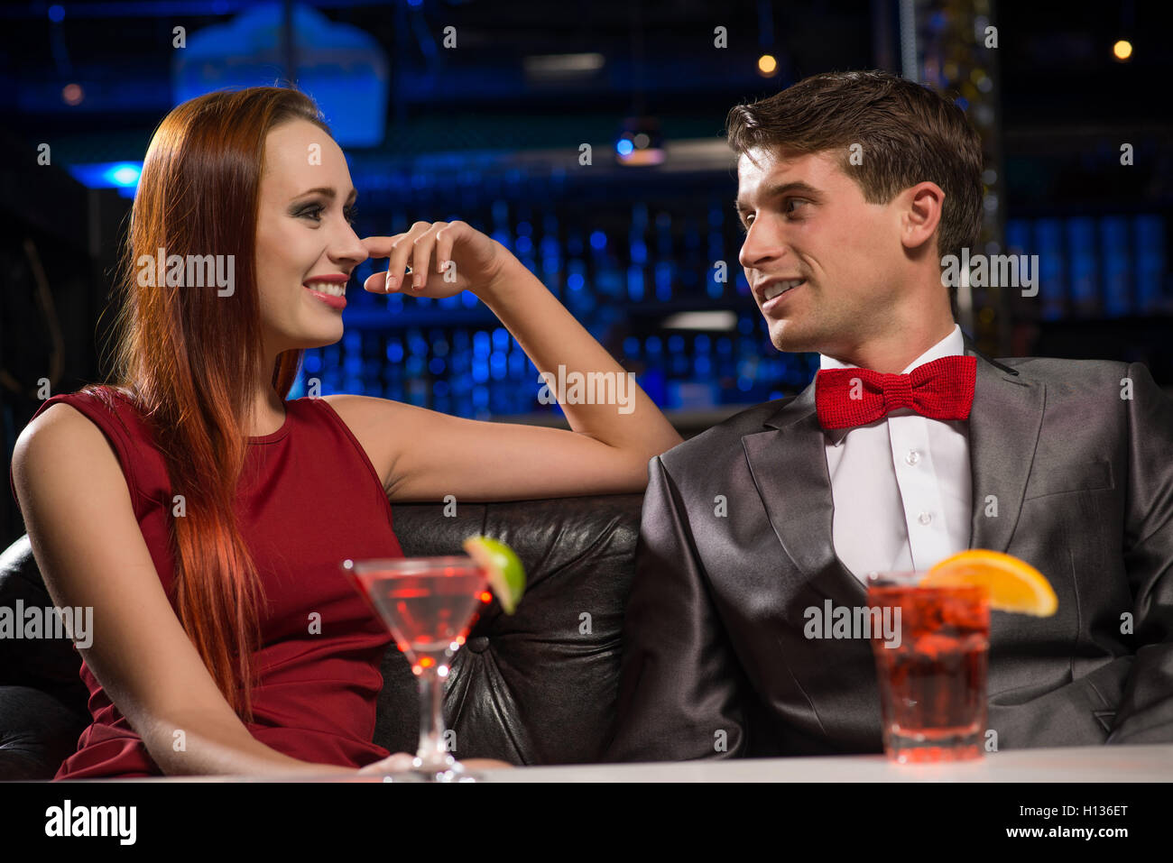 Young couple talking in a nightclub Stock Photo - Alamy