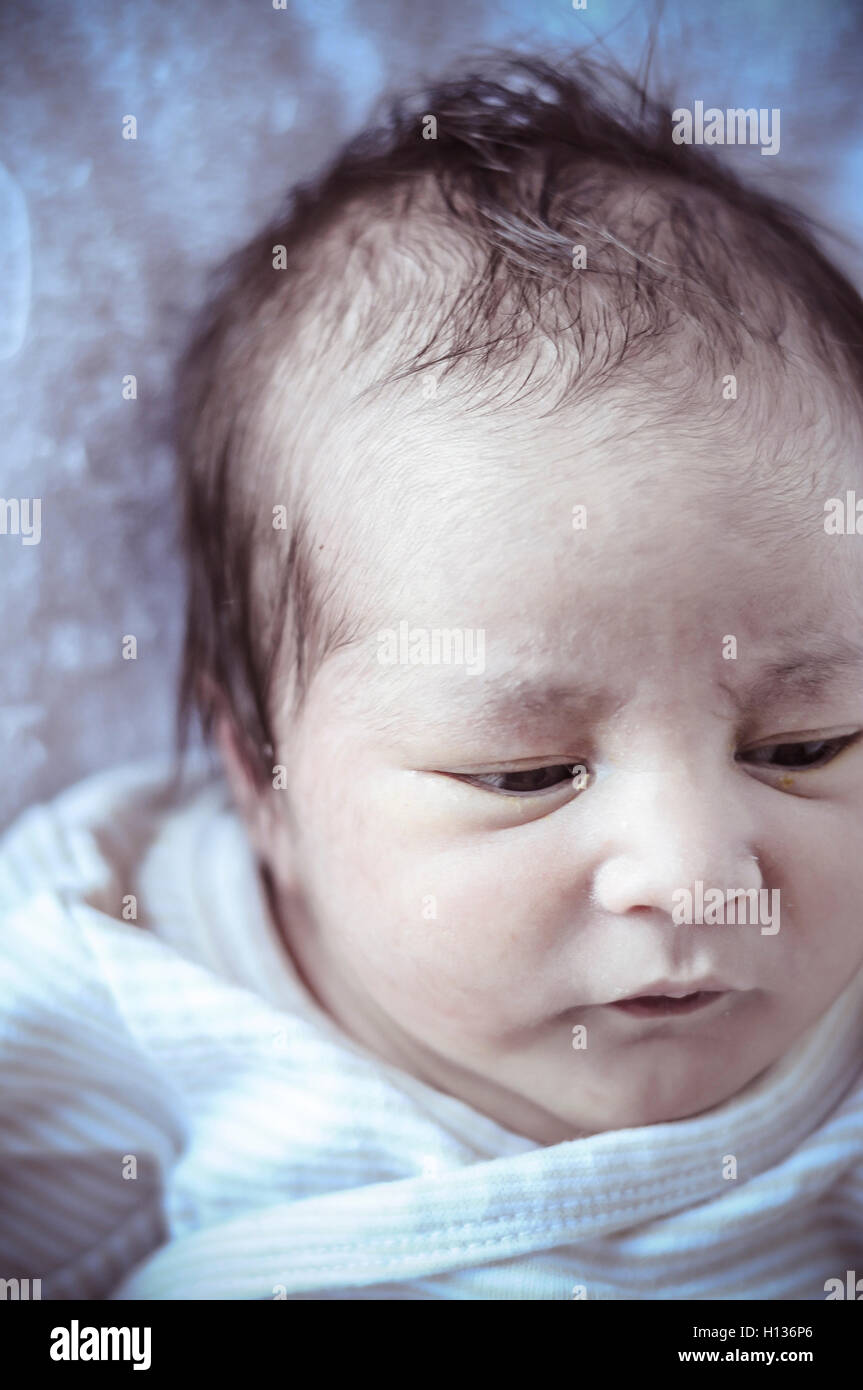 new born baby curled up sleeping on a blanket, multiple expressi Stock ...