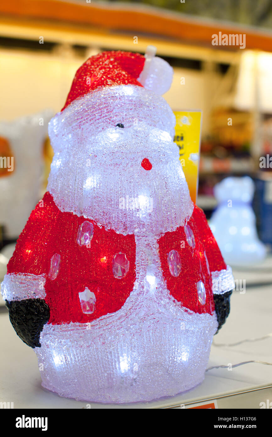 Figures of Santa with light bulbs inside in supermarket Stock Photo - Alamy