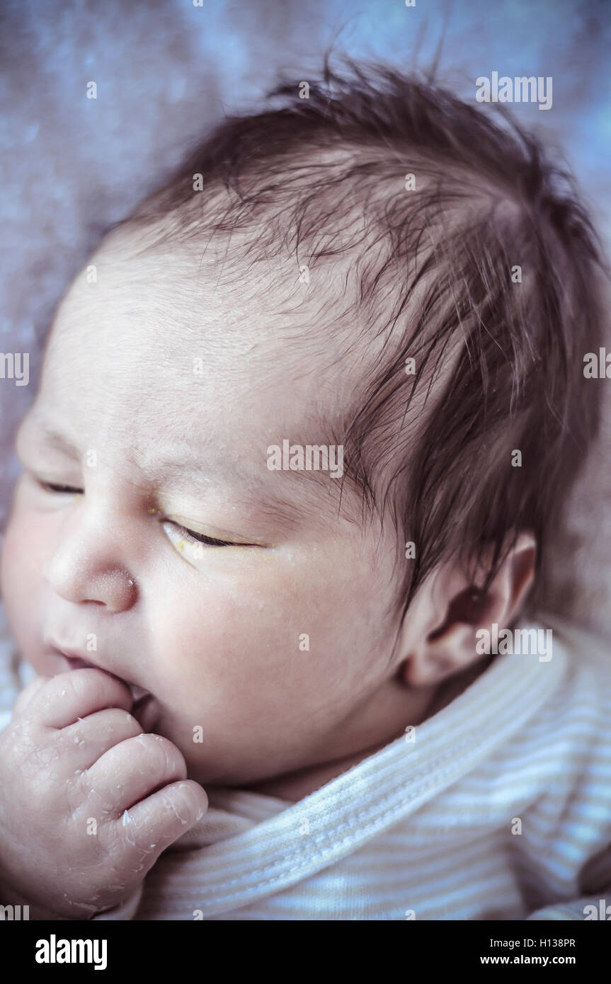 new born baby curled up sleeping on a blanket, multiple expressi Stock ...