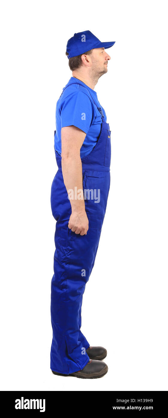 Worker in blue overalls. Side view Stock Photo - Alamy