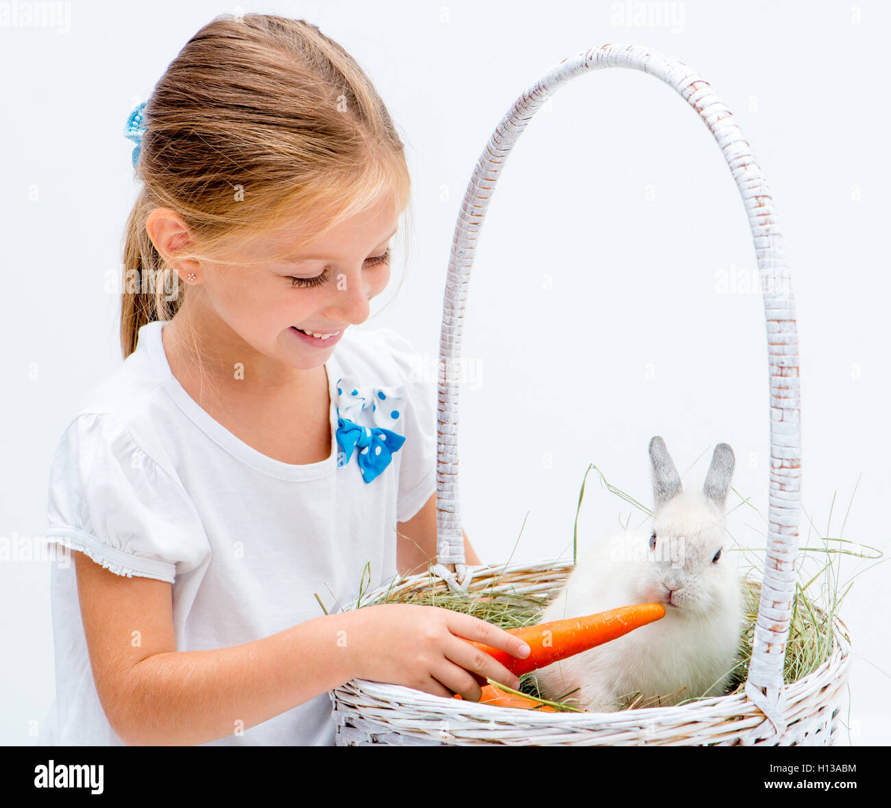 Little girl with a rabbit Stock Photo - Alamy