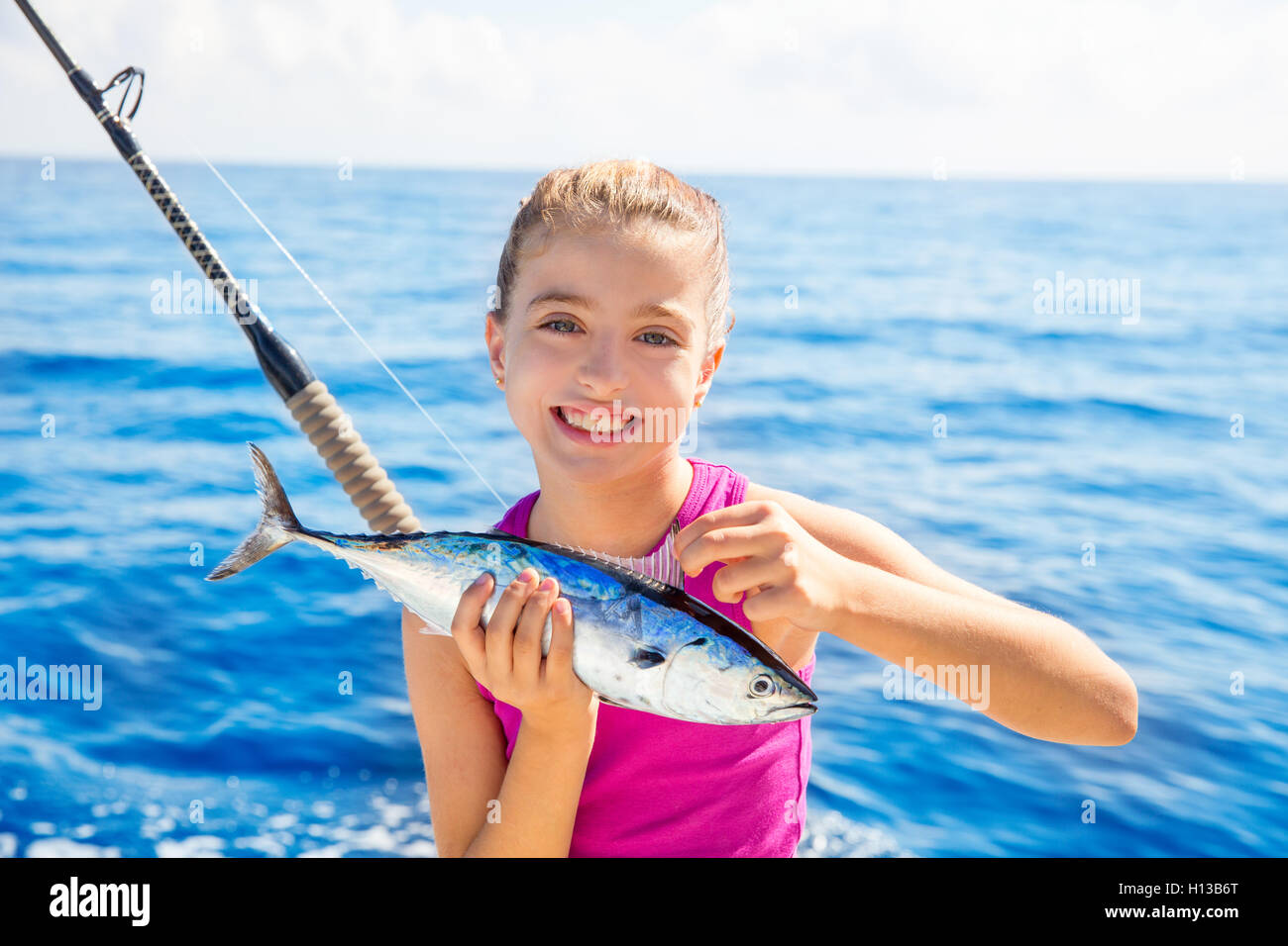 Kid girl fishing tuna little tunny happy with fish catch Stock Photo ...