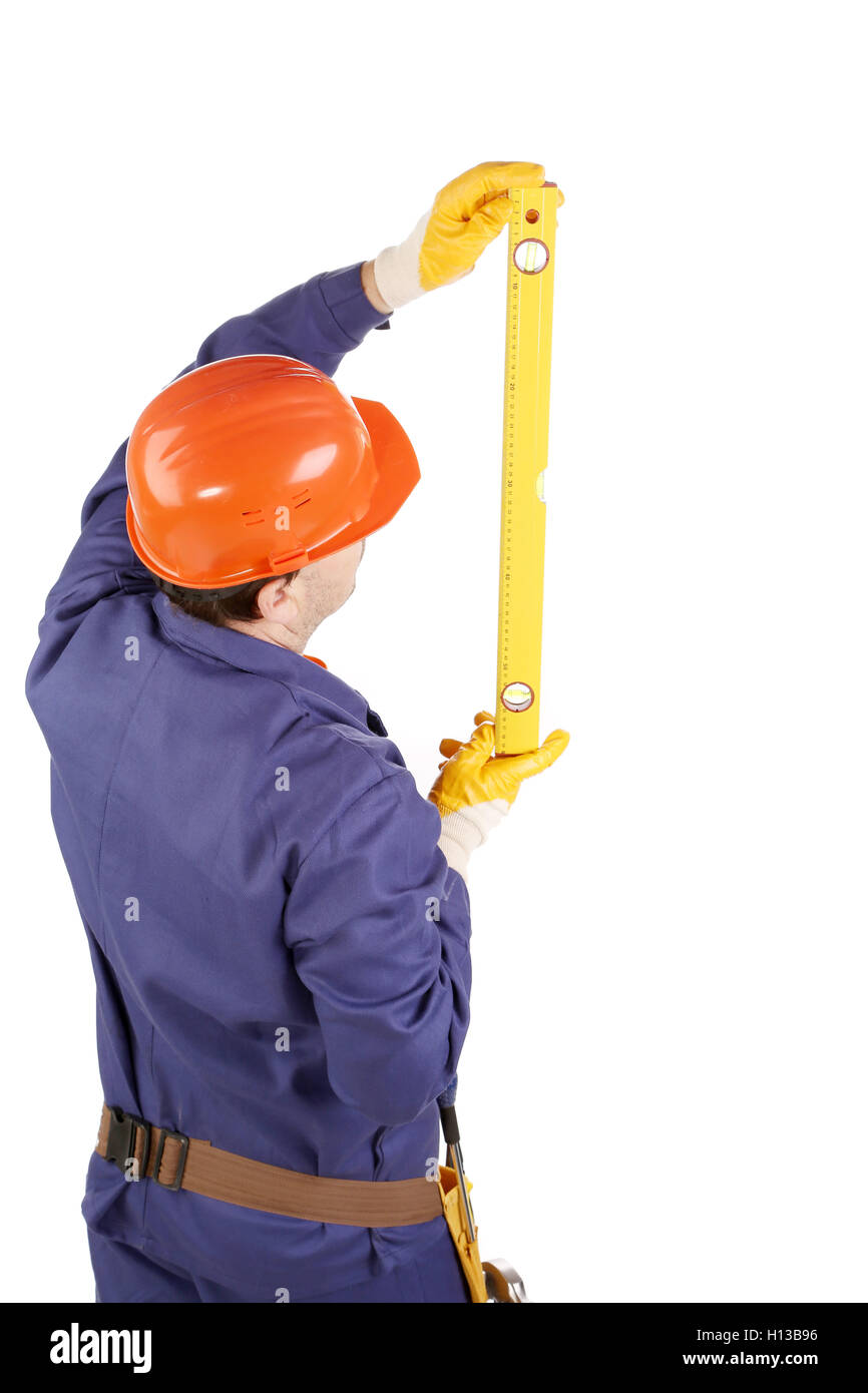 Worker in hard hat raising ruler Stock Photo - Alamy