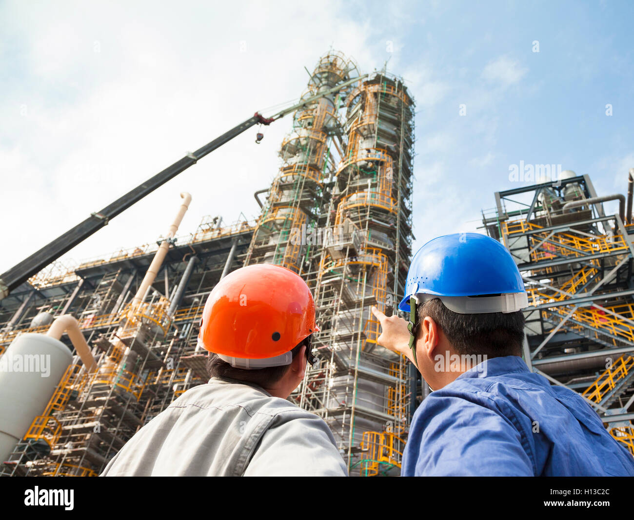 two Factory workers discussion and pointing for inspection Stock Photo ...
