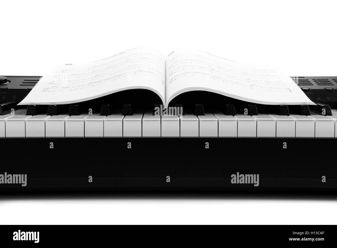 Piano keys and musical book Stock Photo - Alamy