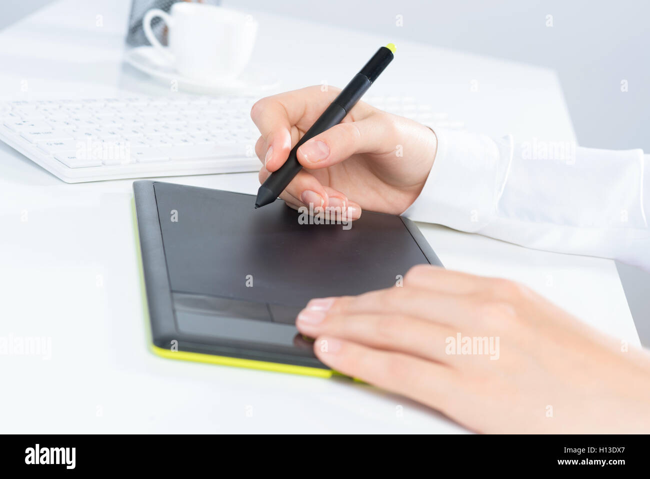 Designer hand drawing a graph on the tablet Stock Photo - Alamy