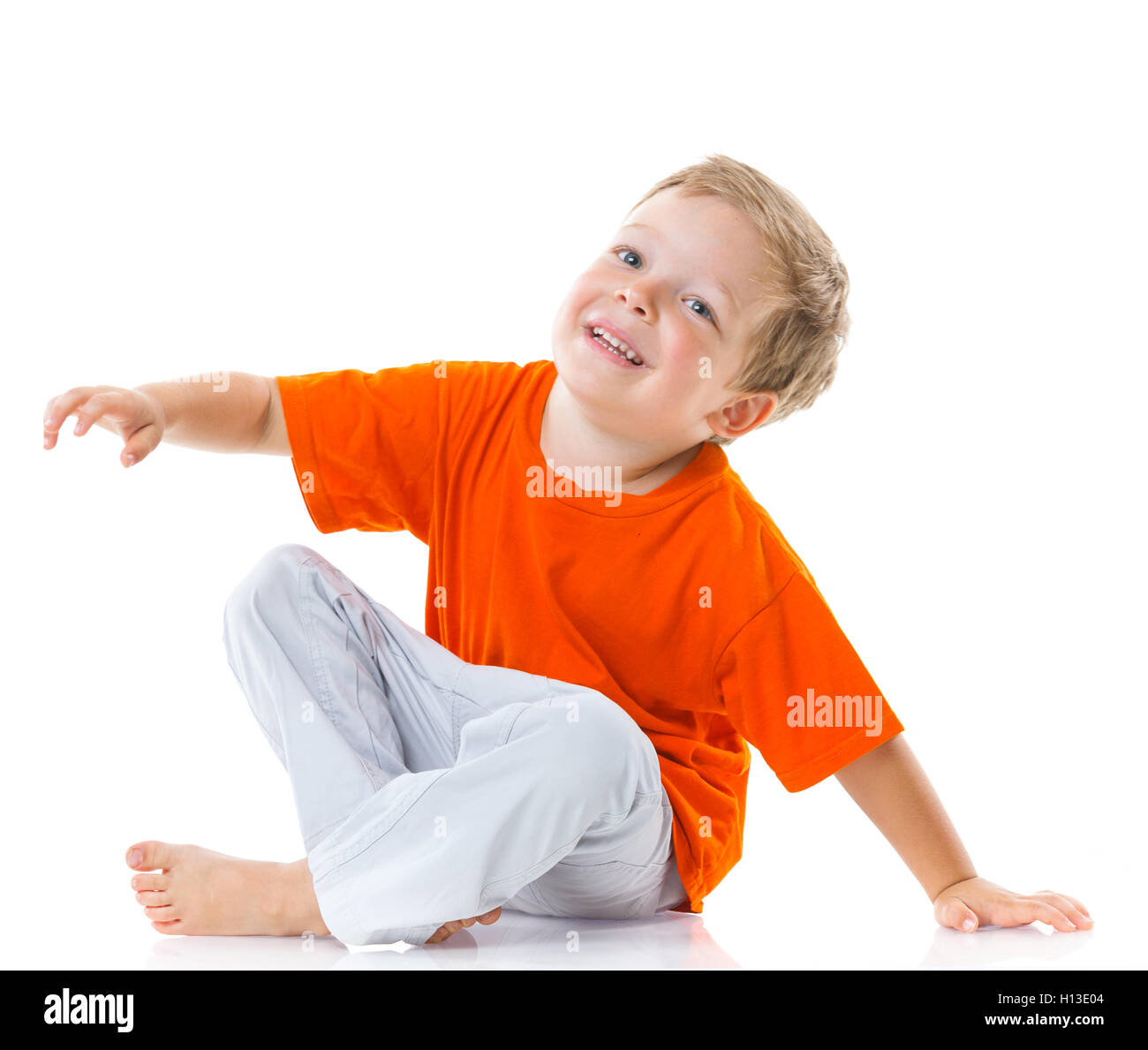 Happy boy sitting on the floor Stock Photo - Alamy