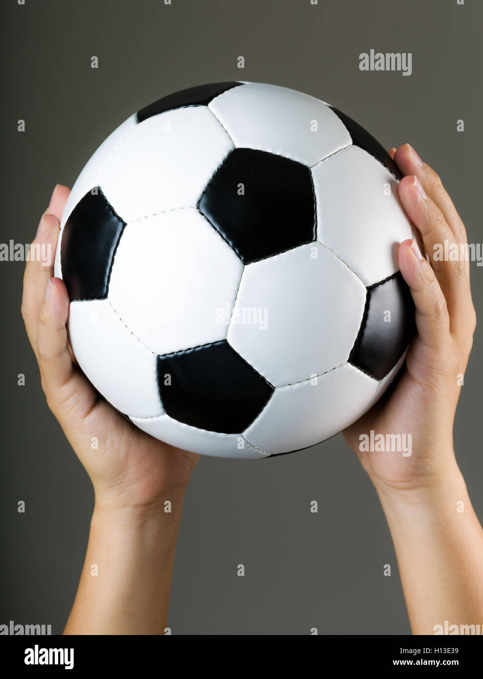 Hand holding soccer ball Stock Photo - Alamy