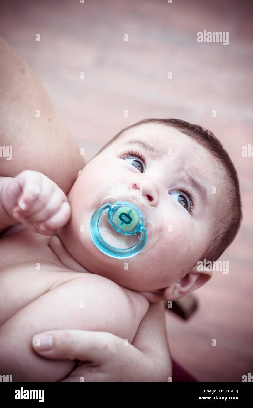 new born baby curled up sleeping on a blanket, multiple expressi Stock ...