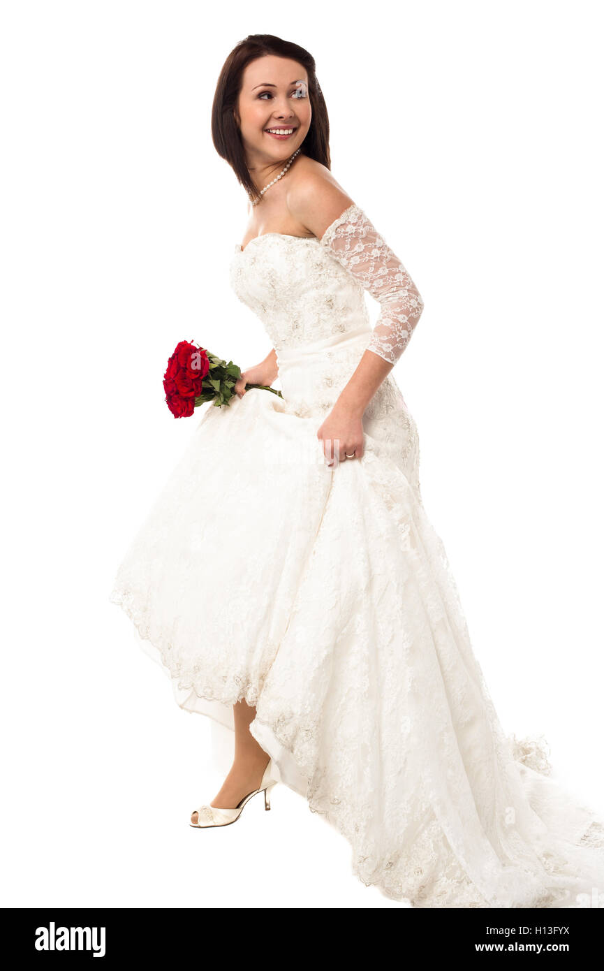 Pretty bride turns back and moving forward Stock Photo - Alamy