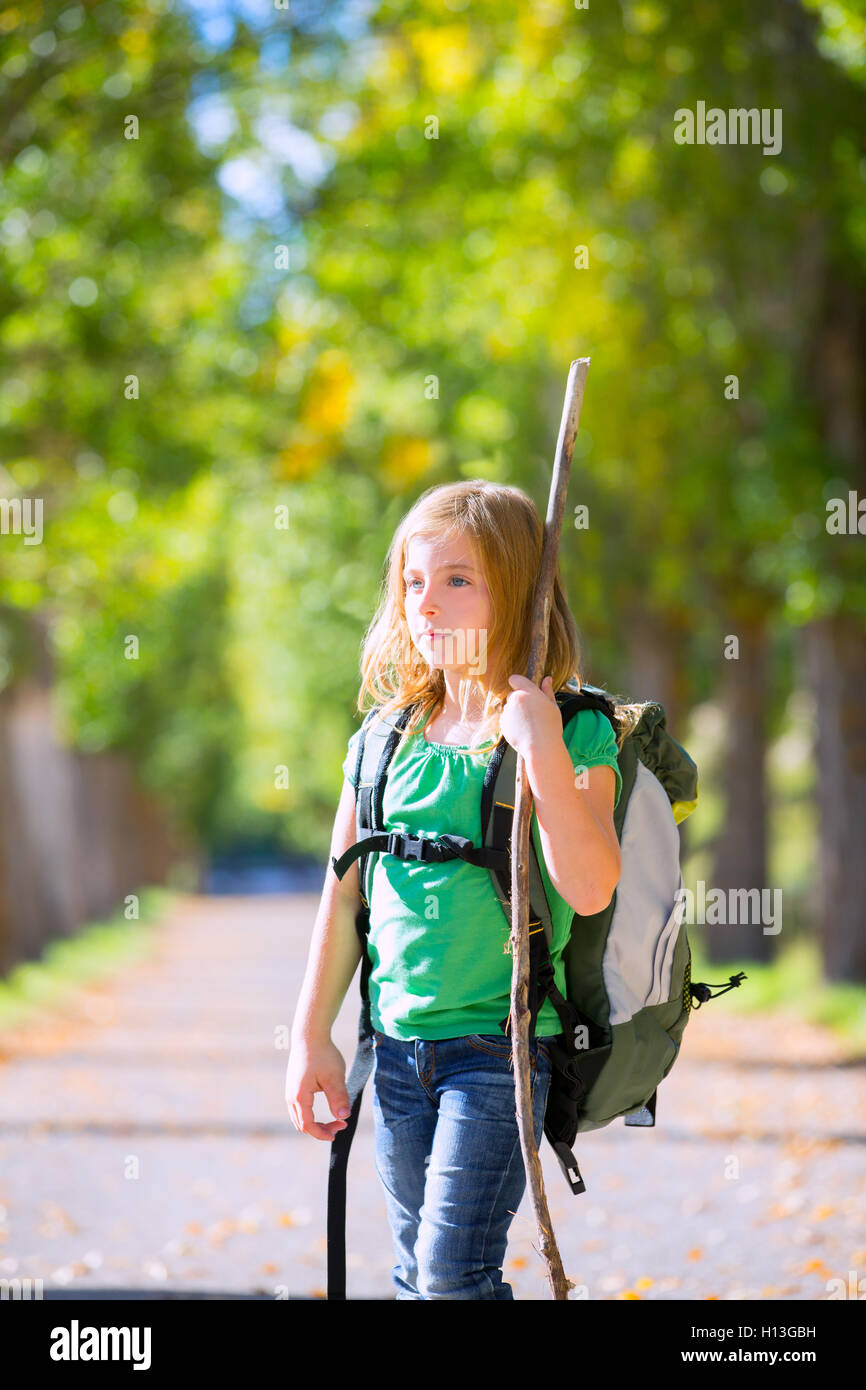 Blond explorer kid girl walking with backpack in autumn trees Stock ...