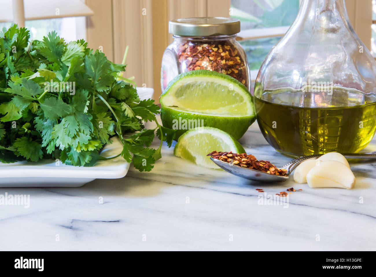 Mexican food ingredients in a kitchen on a marble top . Cilantro red ...