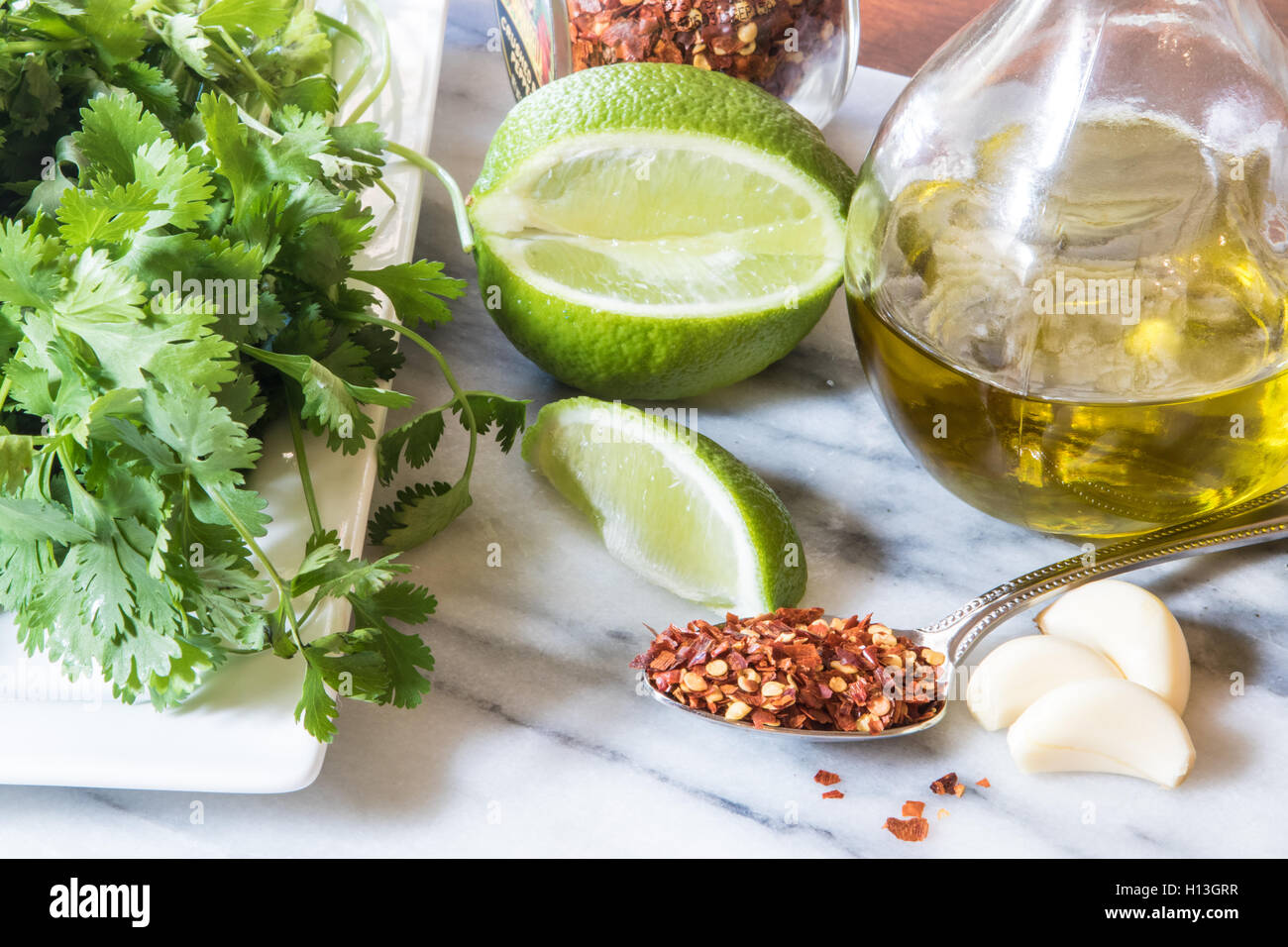 Mexican food ingredients in a kitchen on a marble top . Cilantro red ...