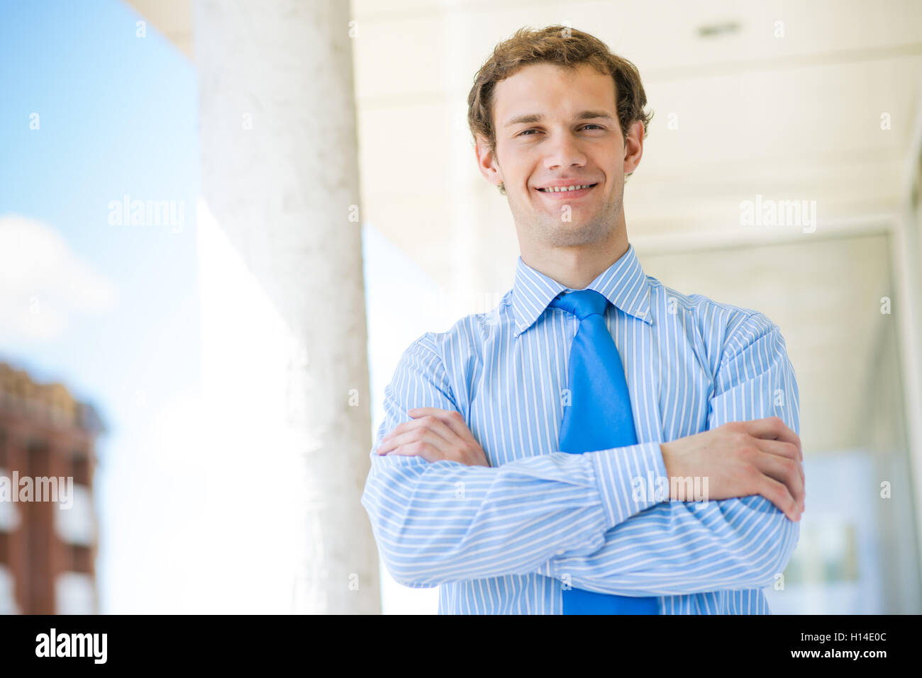 successful young businessman smiling Stock Photo - Alamy