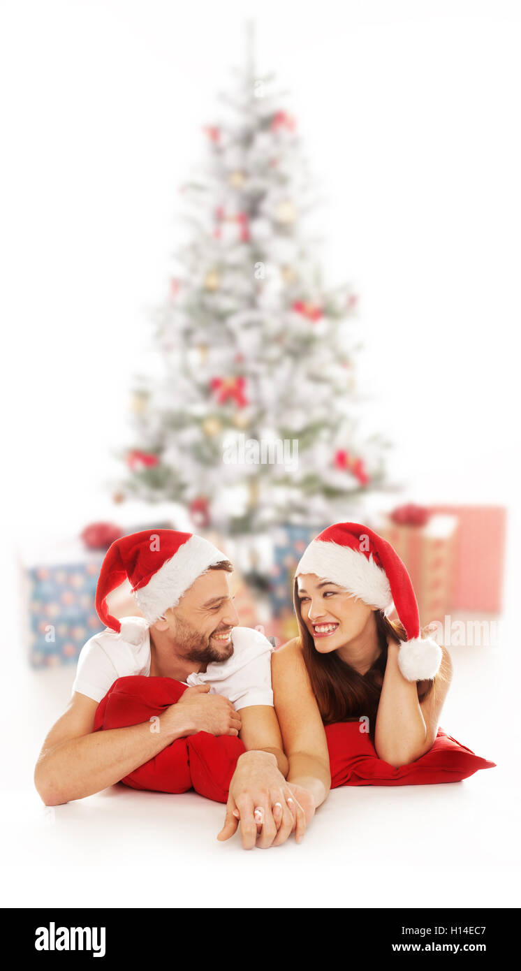 Couple at christmas tree Cut Out Stock Images & Pictures - Alamy