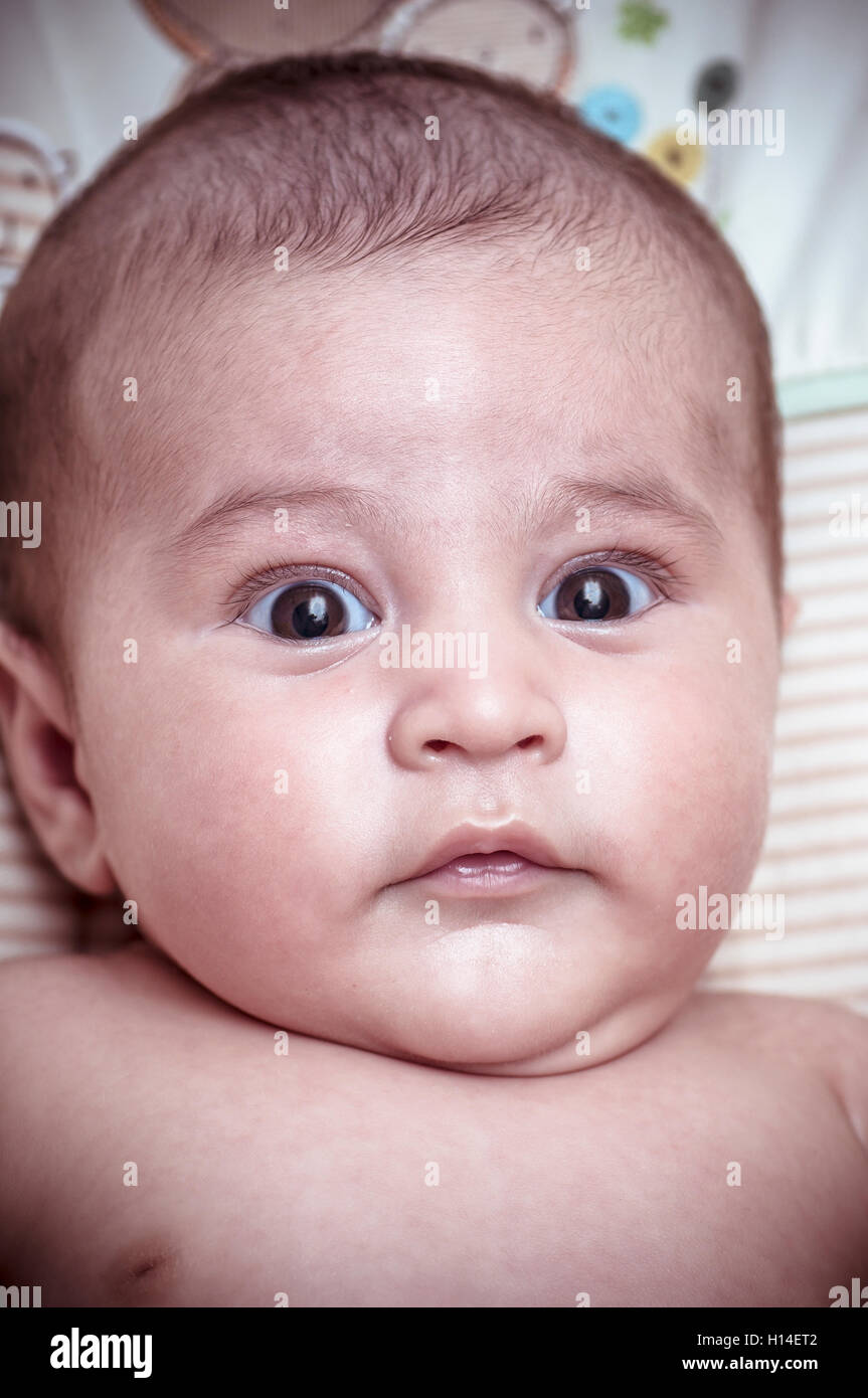 new born baby curled up sleeping on a blanket, multiple expressi Stock ...
