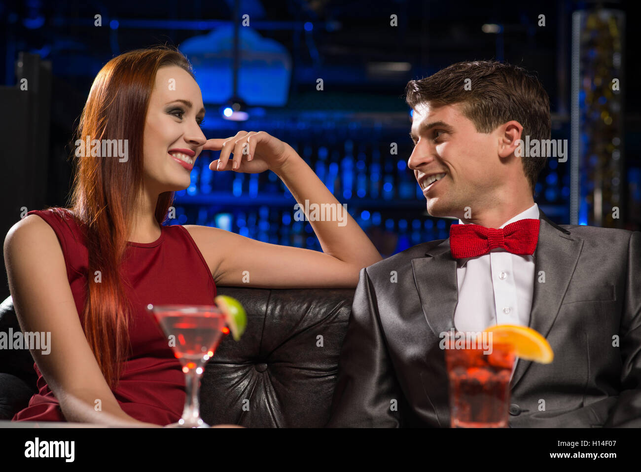 Young couple talking in a nightclub Stock Photo - Alamy