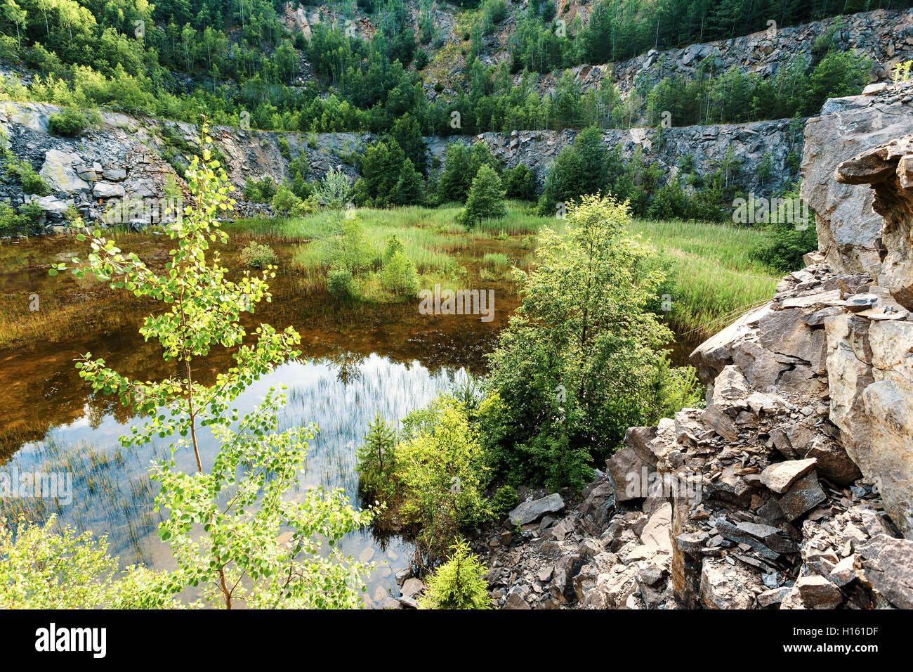 Beautiful landscape of abandoned and flooded quarry with shallow water ...