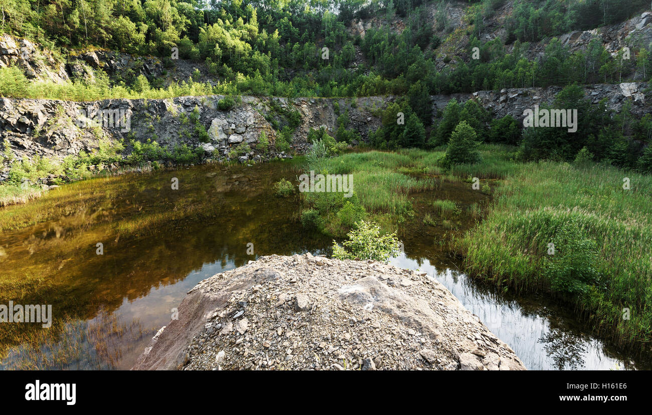 Beautiful landscape of abandoned and flooded quarry with shallow water ...