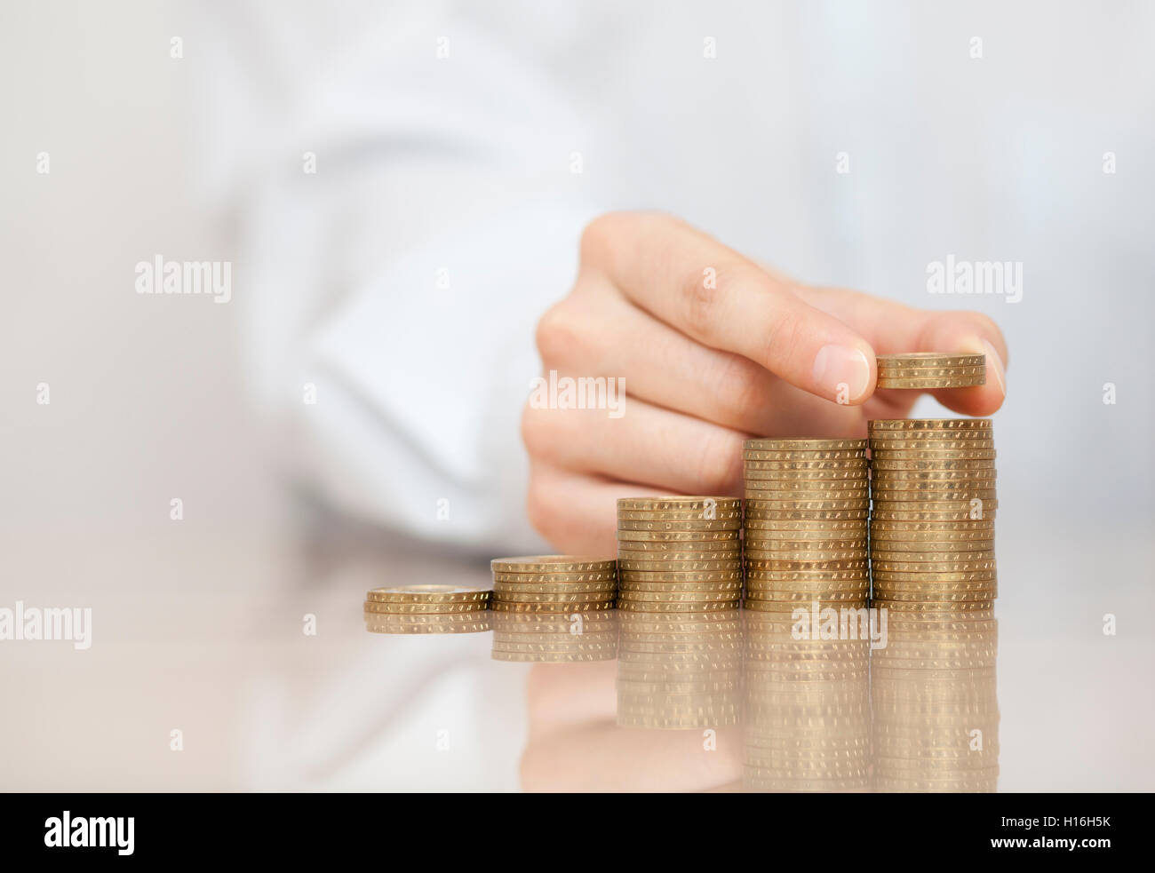 Rising stack of coins Stock Photo - Alamy