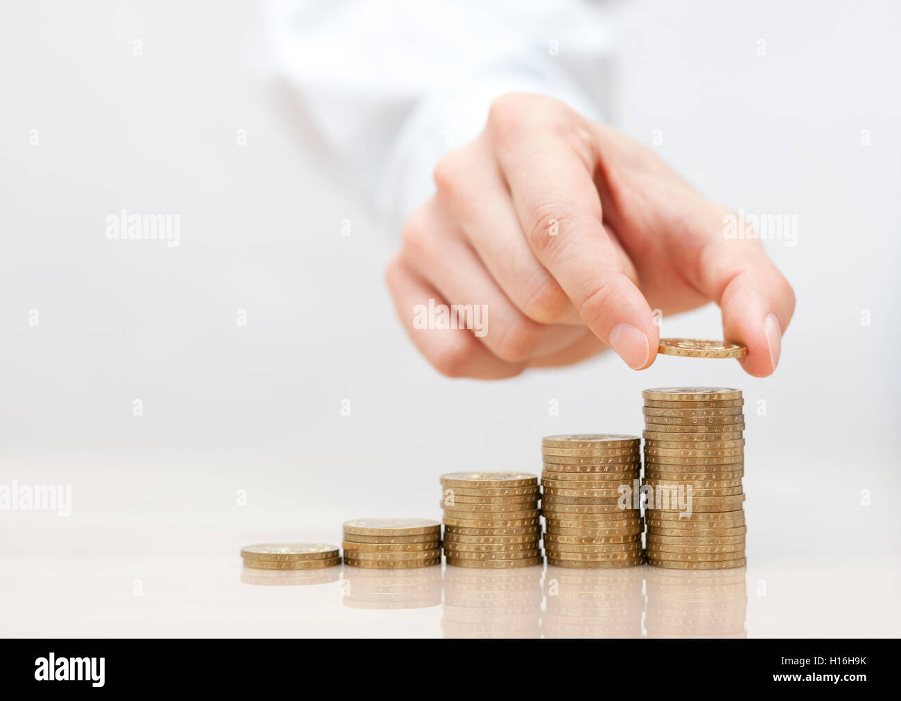 Rising stack of coins Stock Photo - Alamy