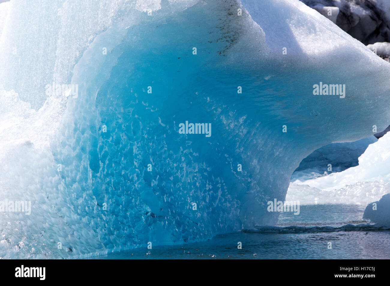 water moulded blue ice iceberg at Jokulsarlon glacial lagoon Iceland ...