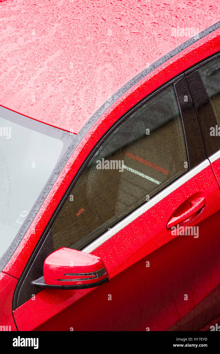 Looking down on a red car roof covered in rain drops Stock Photo - Alamy