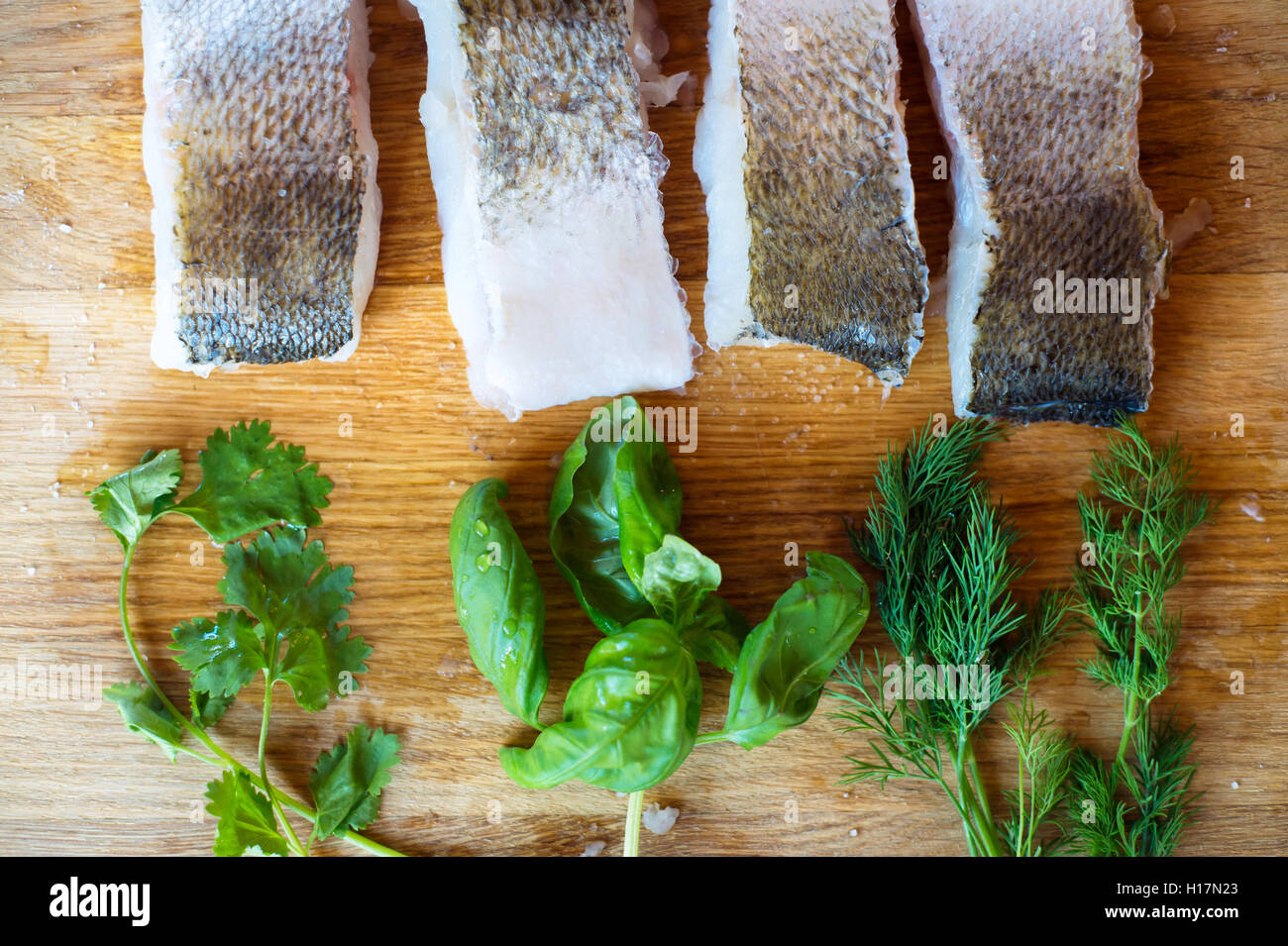 Raw zander fish fillets with various herbs, wooden background Stock ...