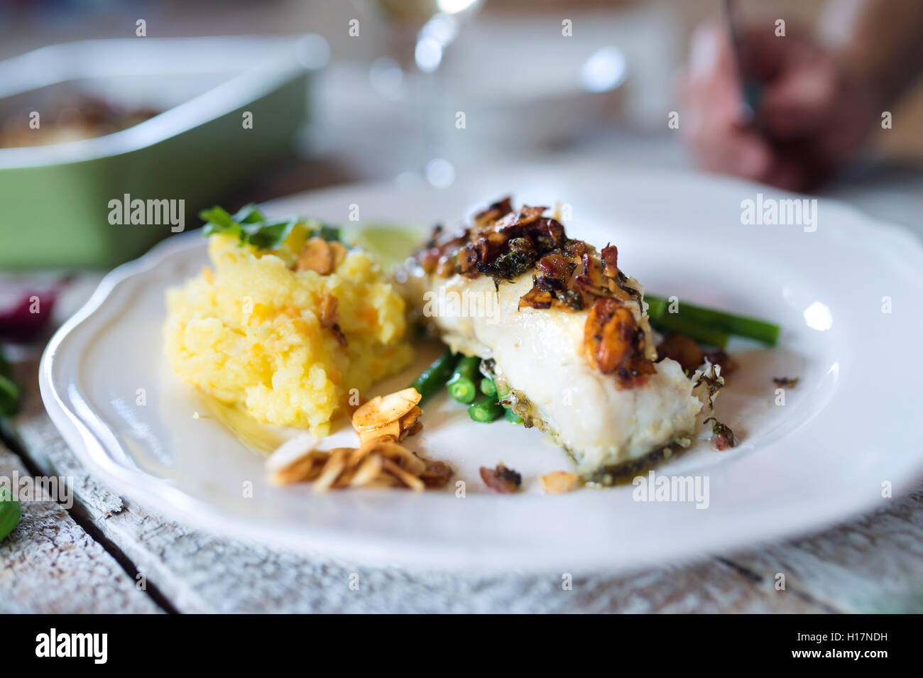 Zander fish fillet dish on a plate, wooden table Stock Photo - Alamy