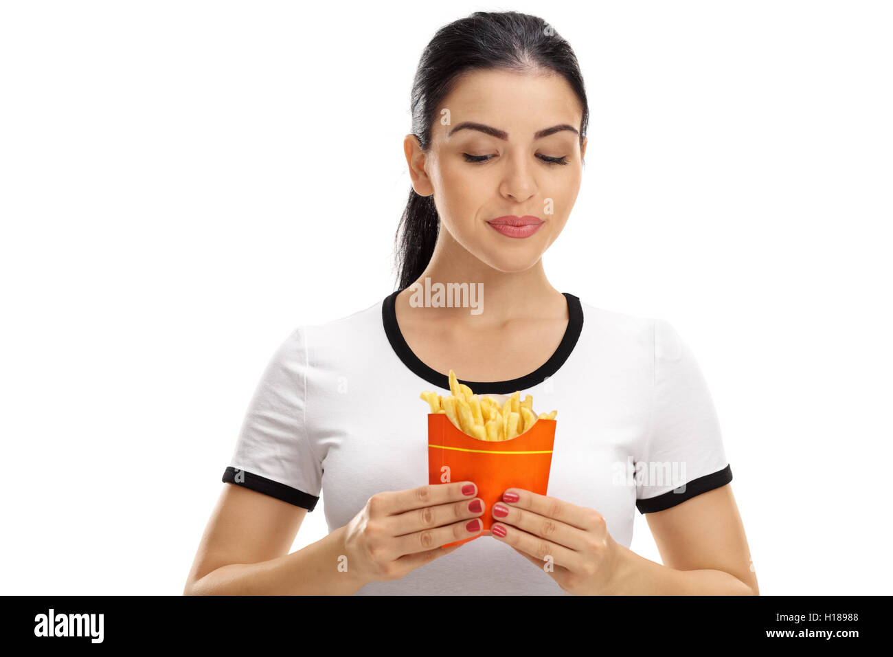 Woman looking at a bag of fries isolated on white background Stock ...