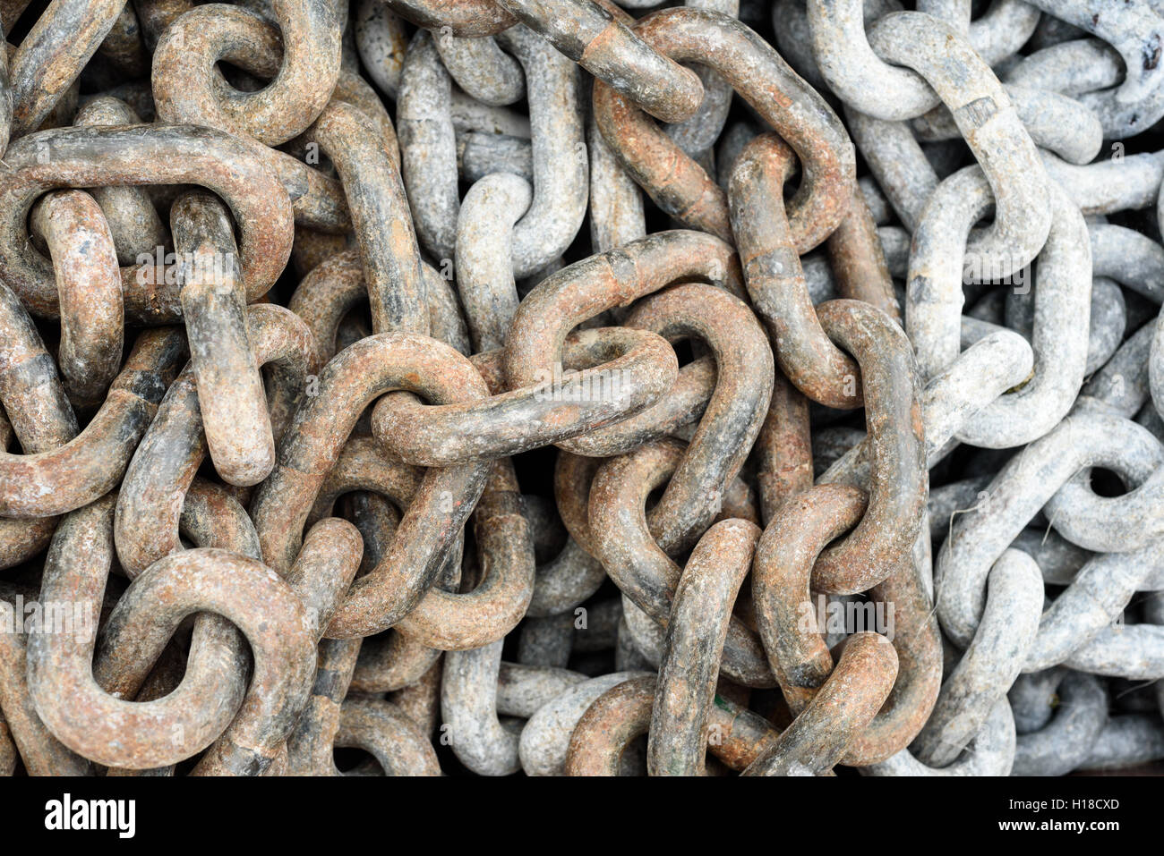 Aged and worn rusty metal chains in a loose pile Stock Photo - Alamy