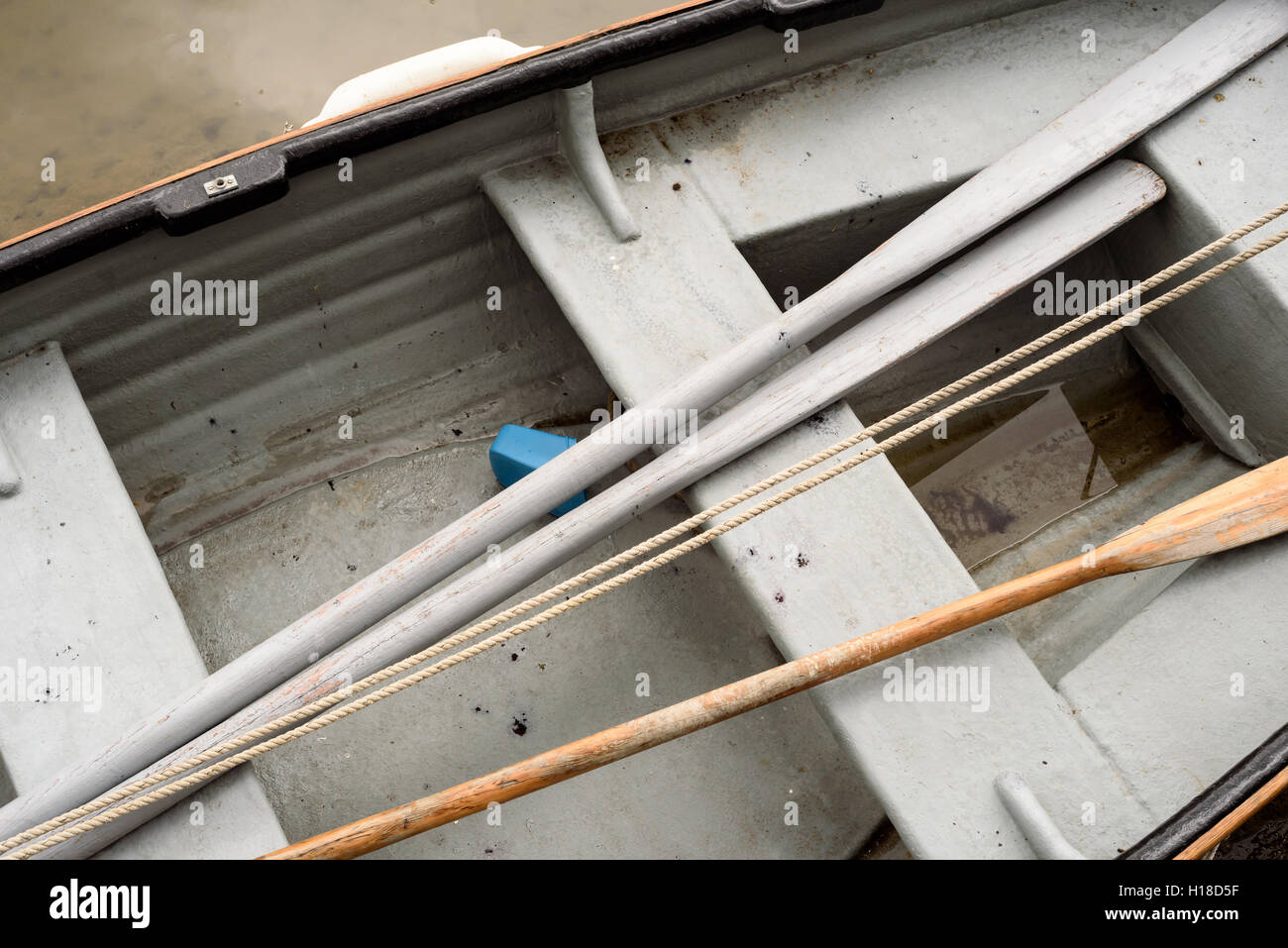 Rowing boat interior with rested oars. The boat is painted grey Stock ...