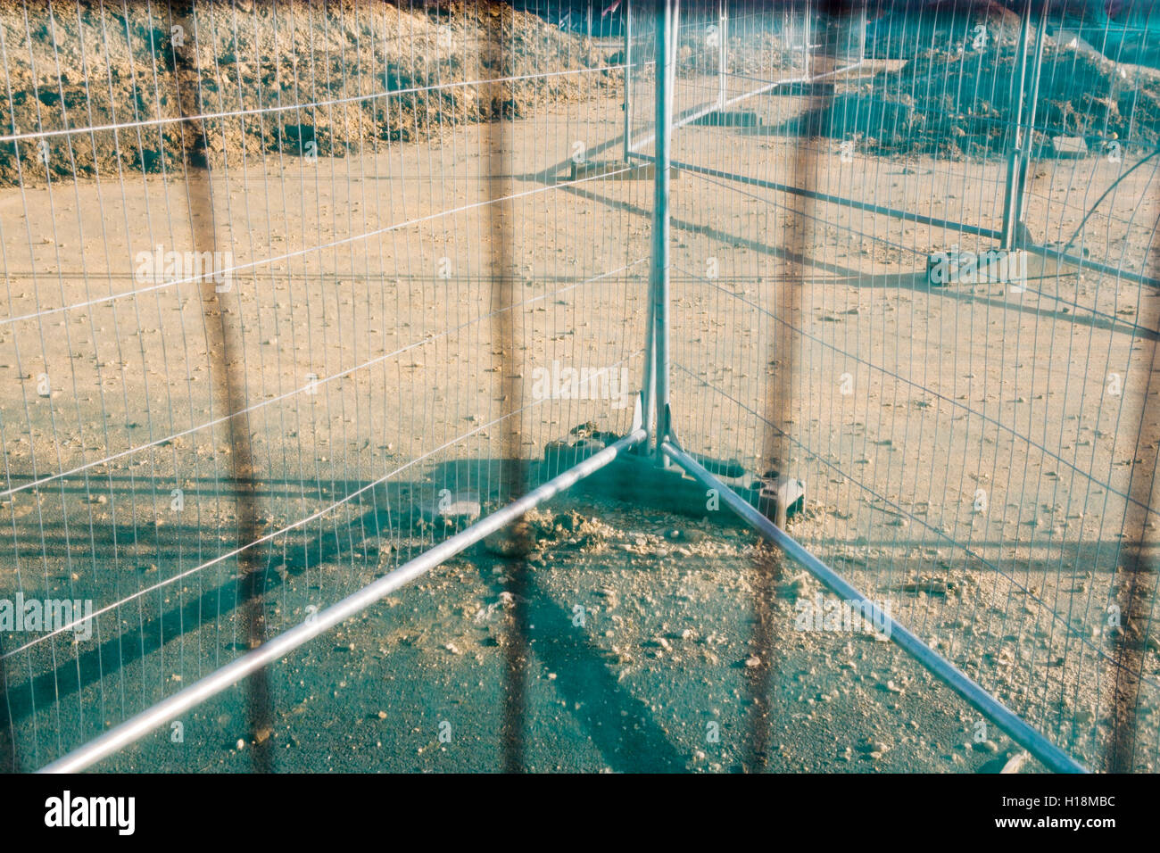 Green netting and metal framed security fence around a building site ...