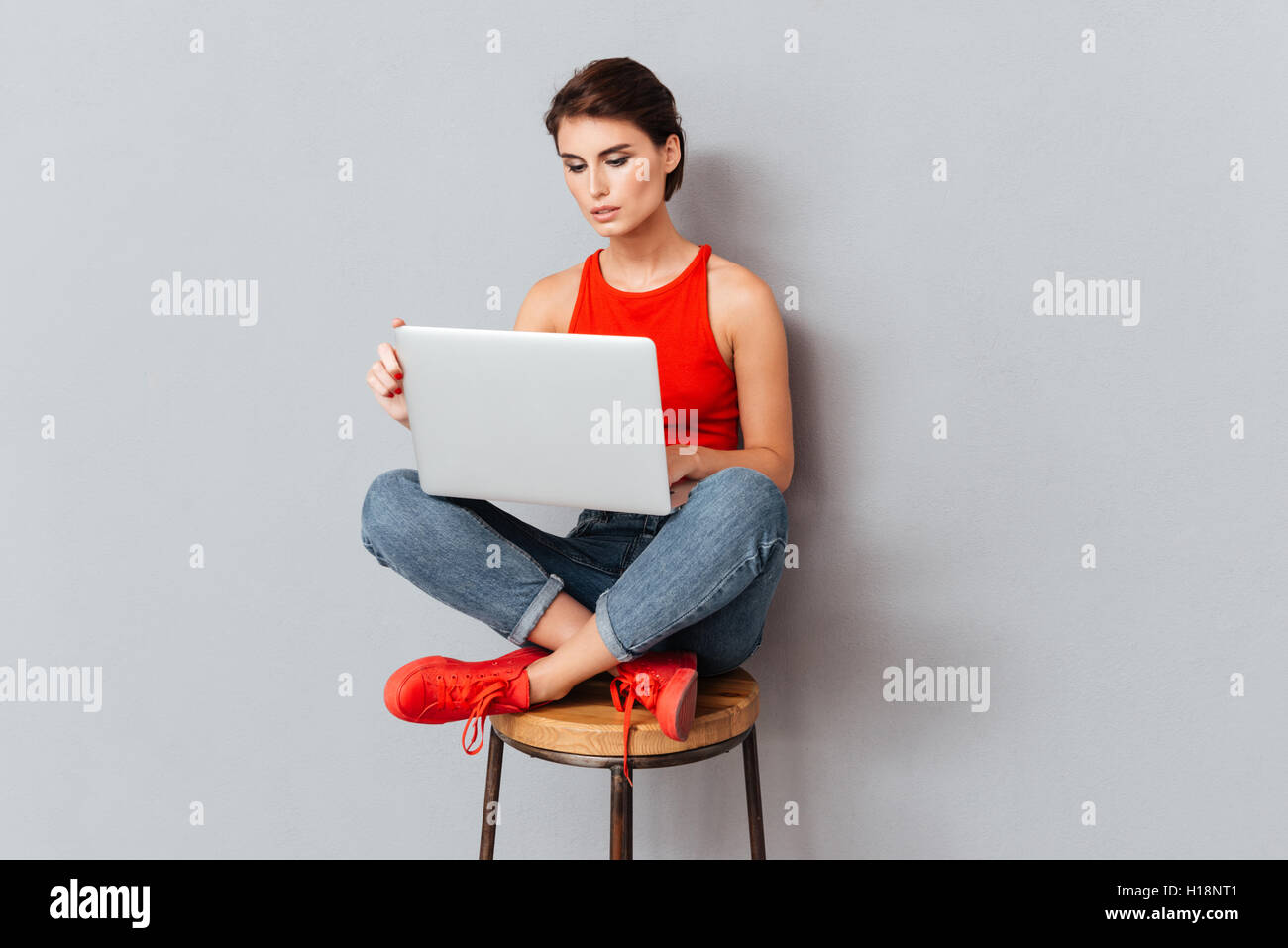 Young beautiful smart girl using laptop pc computer for study isolated ...