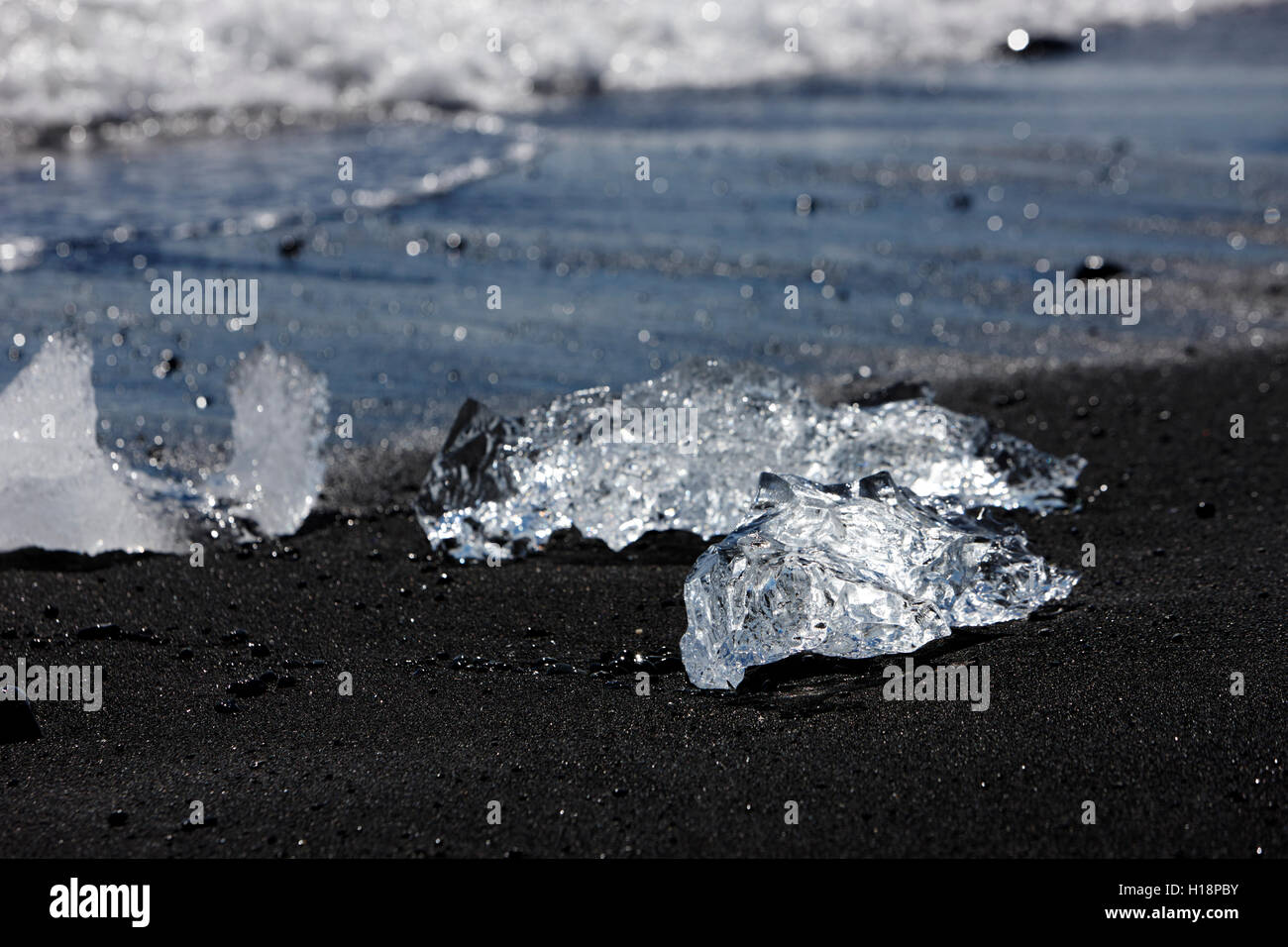 Ice washed up on black sand beach at jokulsarlon iceland Stock Photo ...