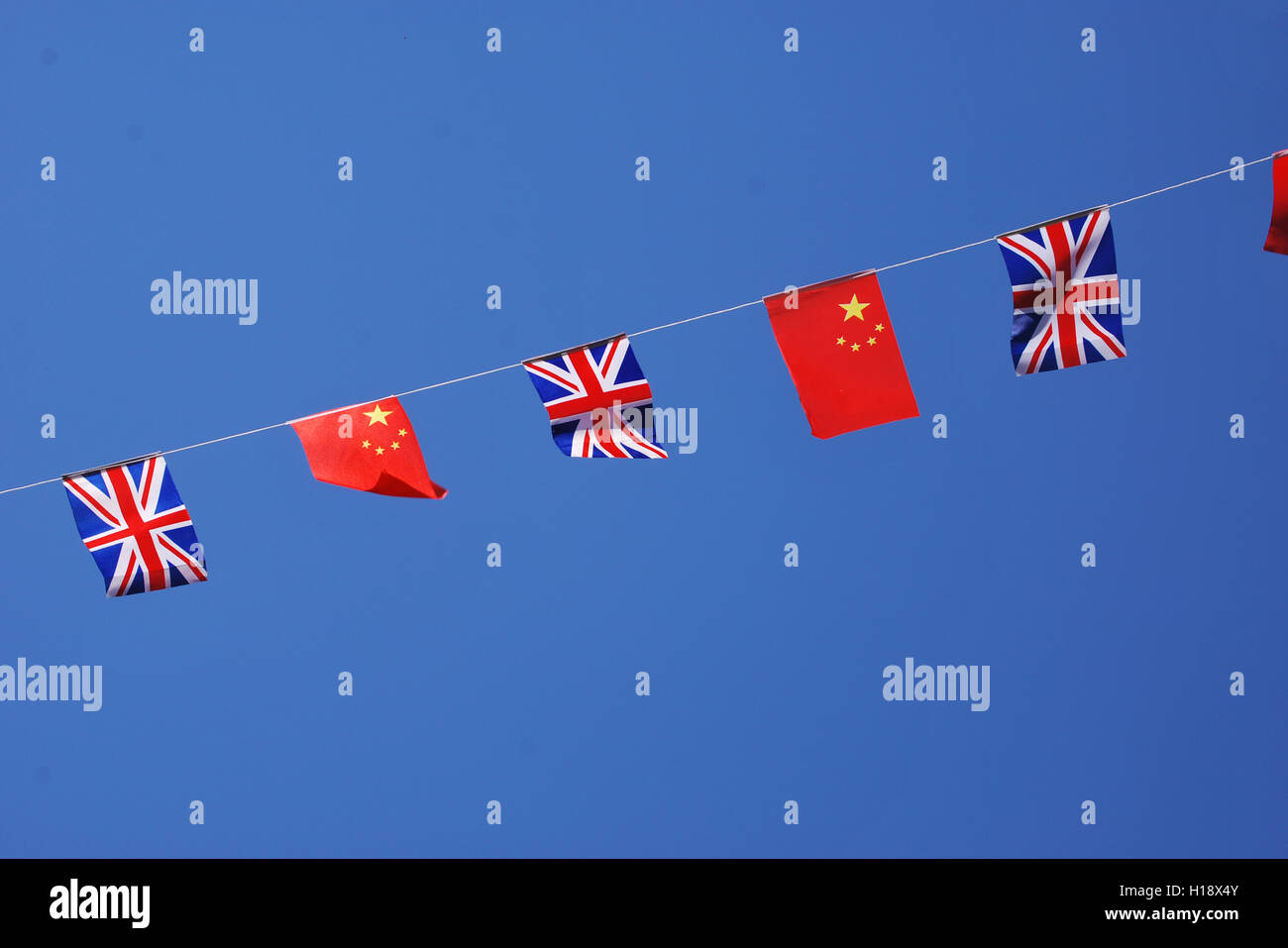 photo of Chinese flags and Union Jacks next to each other against blue ...