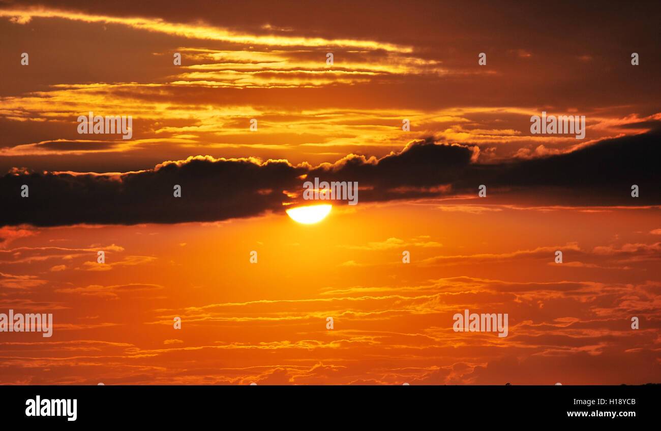 red and gold sunset with dark clouds Stock Photo - Alamy