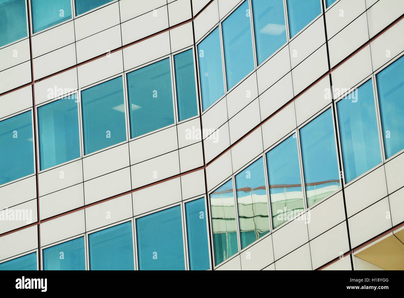 photo of a 70's style building with rows of blue windows Stock Photo ...