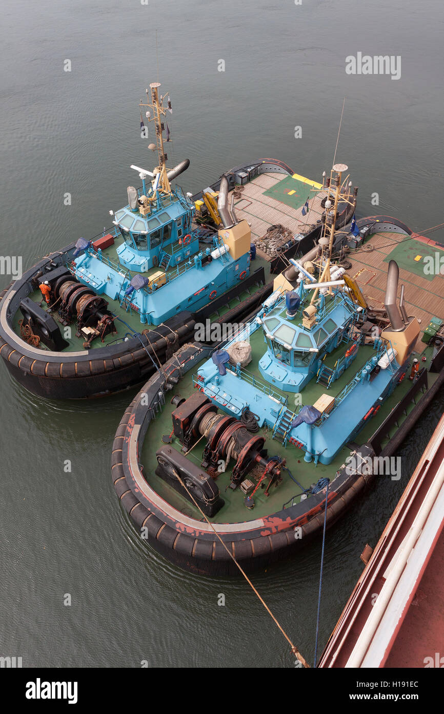 Marine and port operations from jetty.Two tugs tied up and waiting for ...