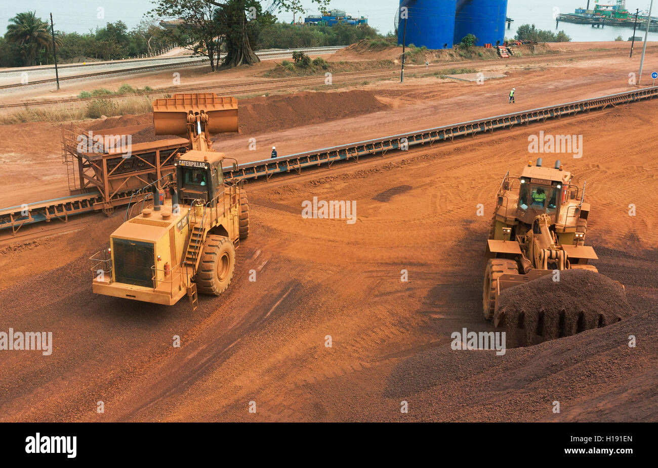 2 Front end loaders loading hopper with lump iron ore from reclaimed ...