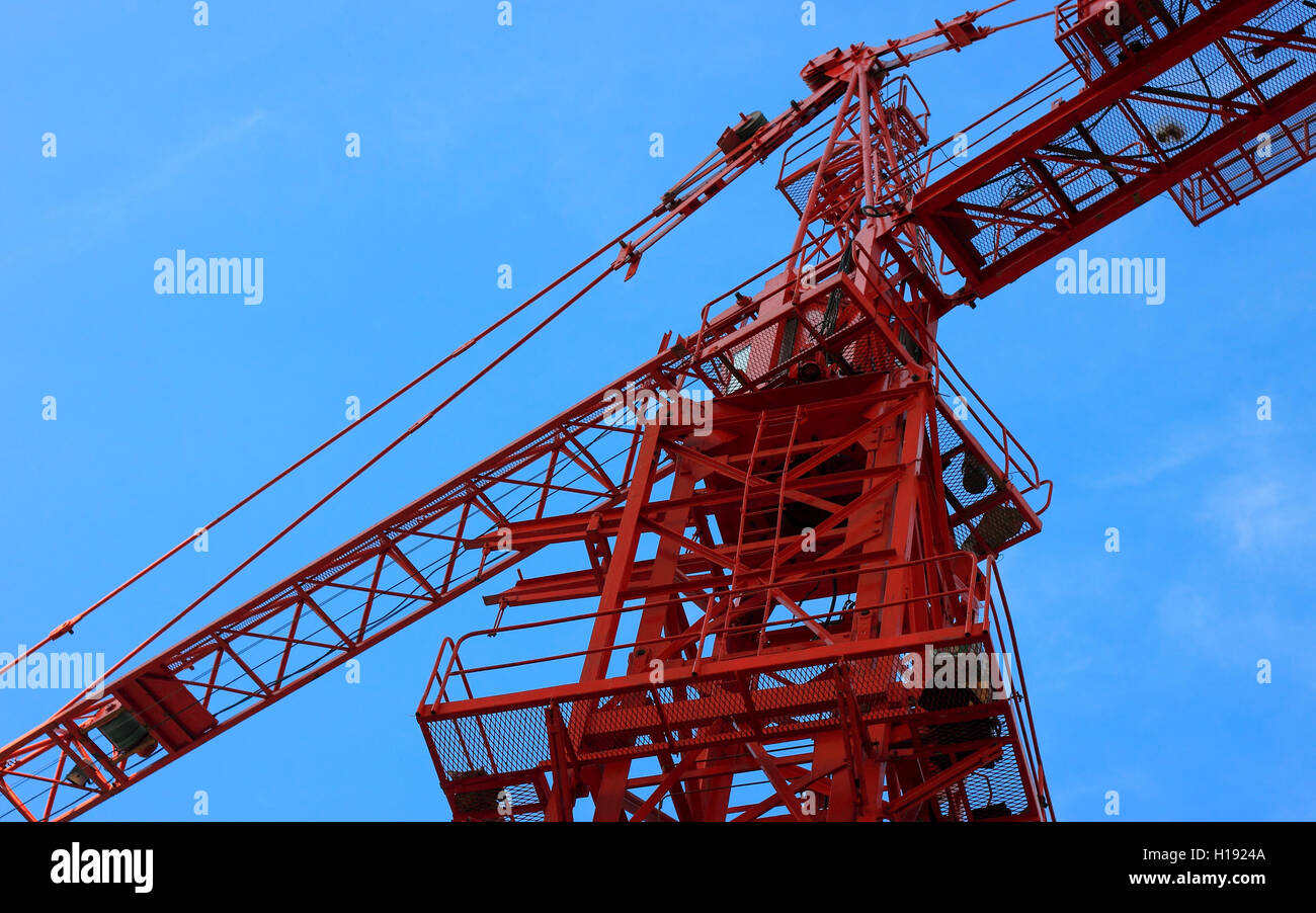 The red crane in construction with the blue sky Stock Photo - Alamy