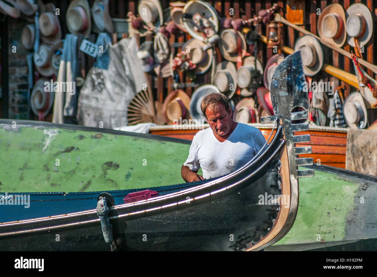 A worker repair a gondola in Venice Stock Photo - Alamy