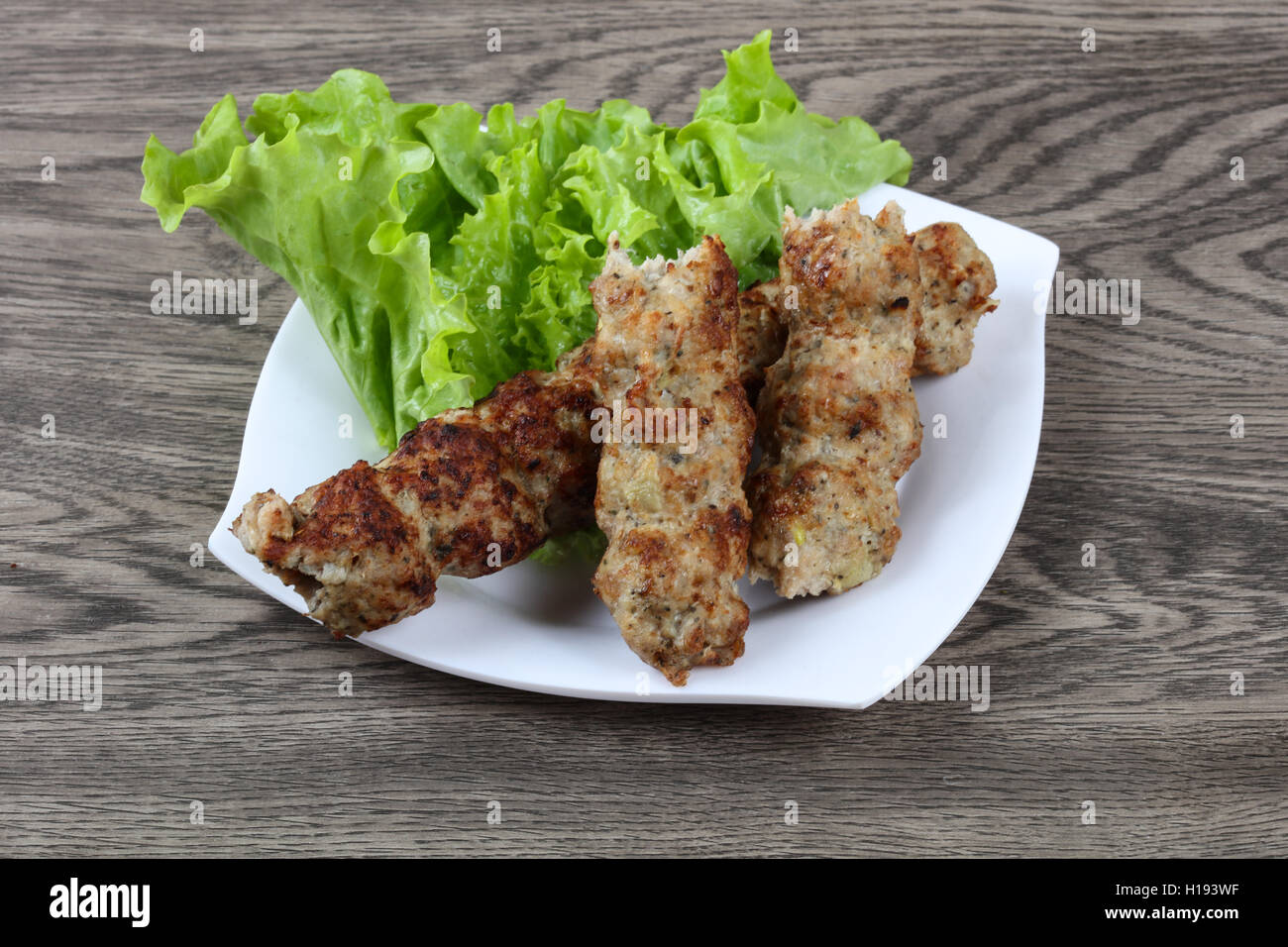 Meat kebab with green salad leaves Stock Photo - Alamy