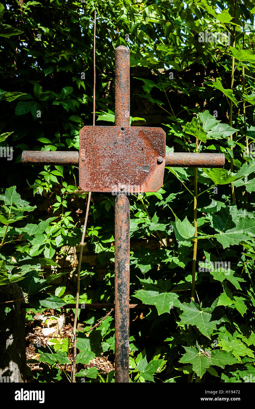 Old rusty metal cross in a cemetery, forgotten grave Stock Photo - Alamy