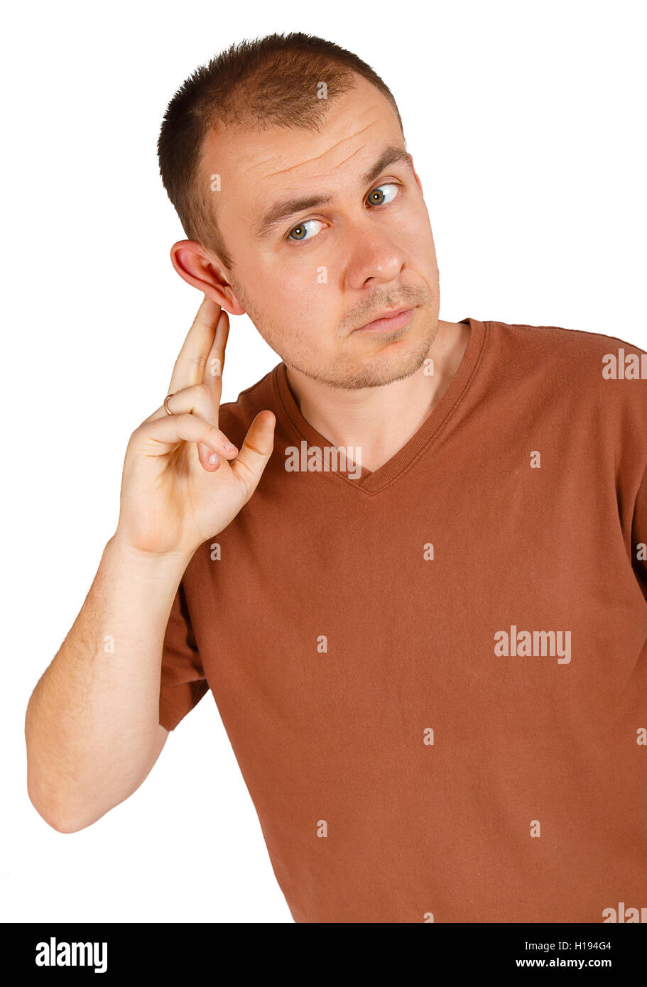 Young man holding hand on his ear isolated on white background Stock ...