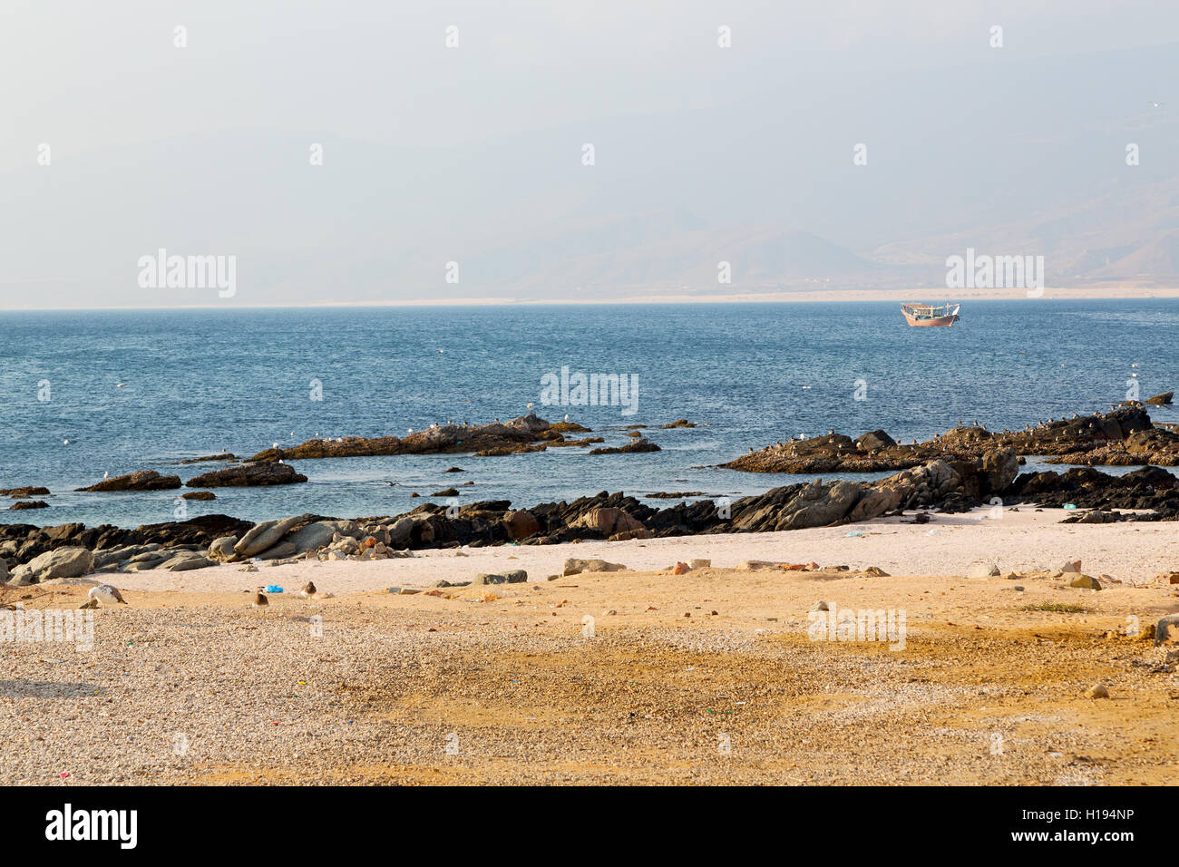 near sandy beach sky and mountain in oman arabic sea Stock Photo - Alamy