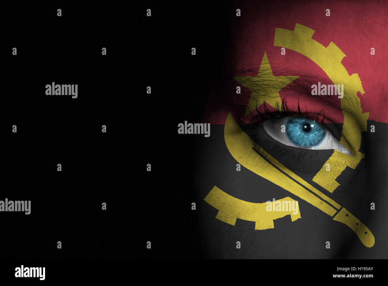 A young female with the flag of Angola painted on her face on her way ...