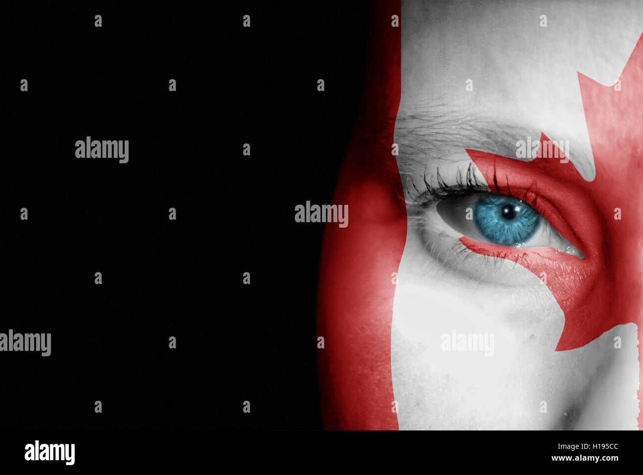 A young female with the flag of Canada painted on her face on her way ...